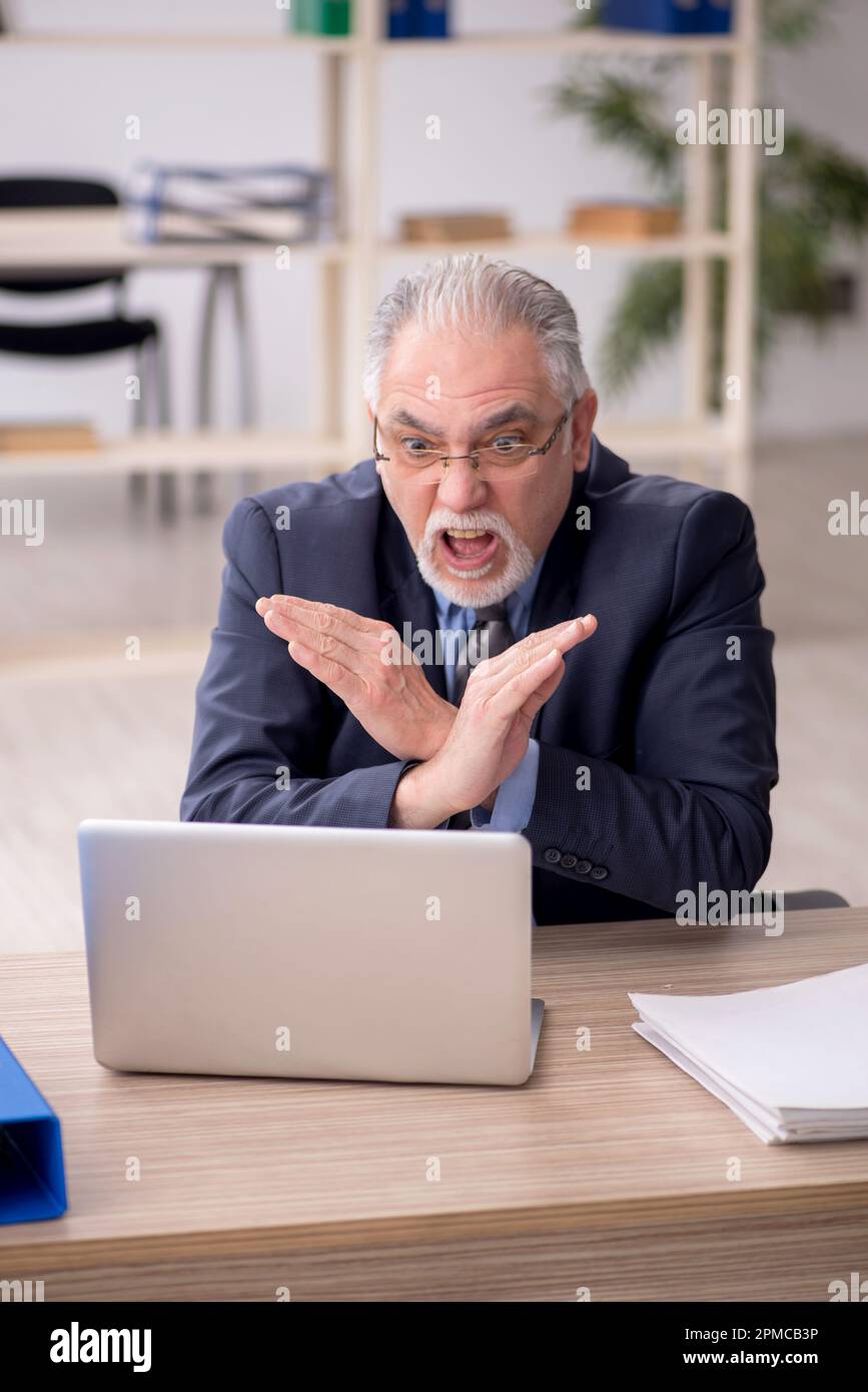Old boss employee working at workplace Stock Photo - Alamy