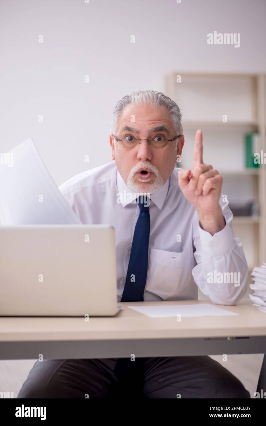 Old boss employee working at workplace Stock Photo - Alamy