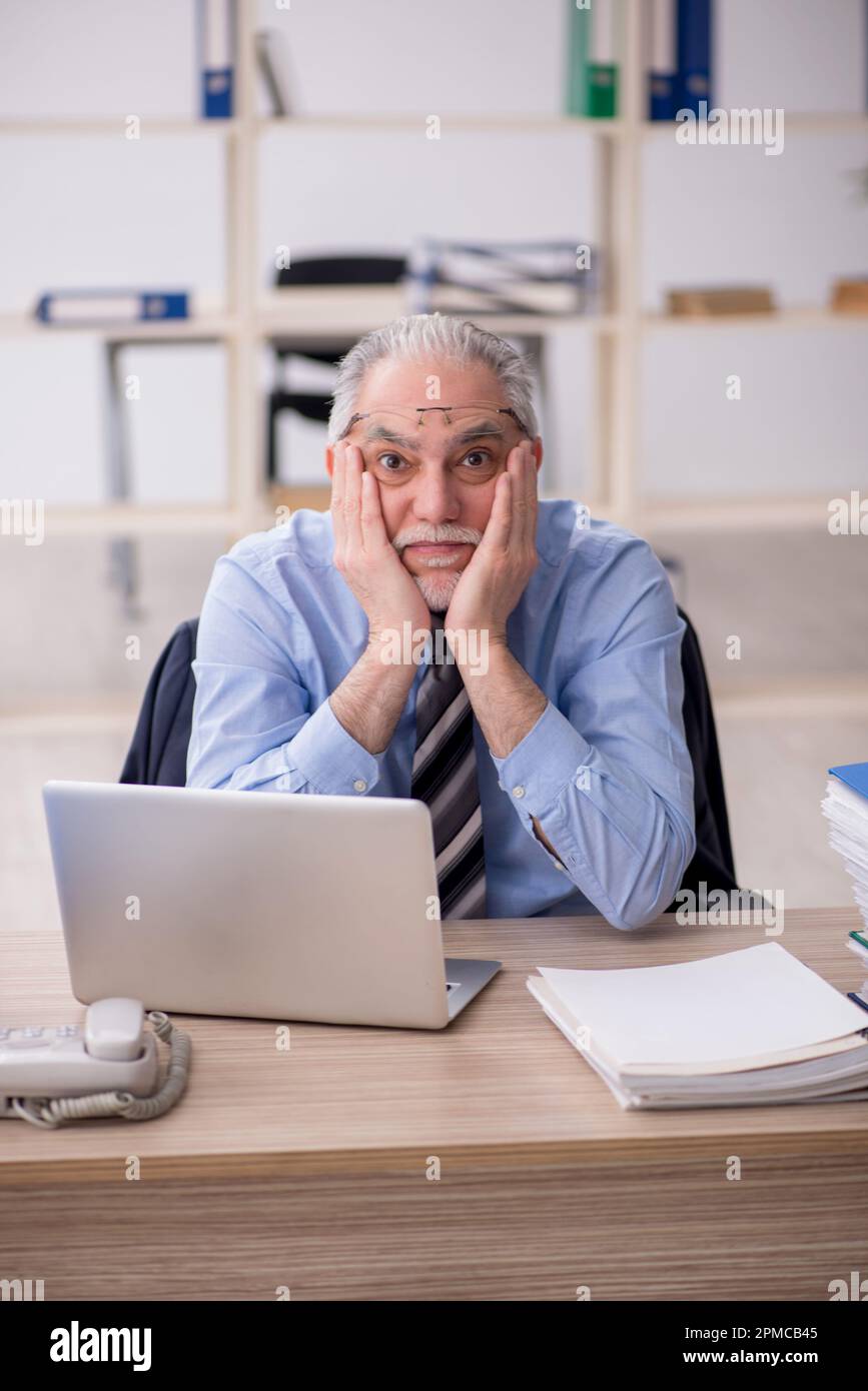 Old boss employee working at workplace Stock Photo - Alamy
