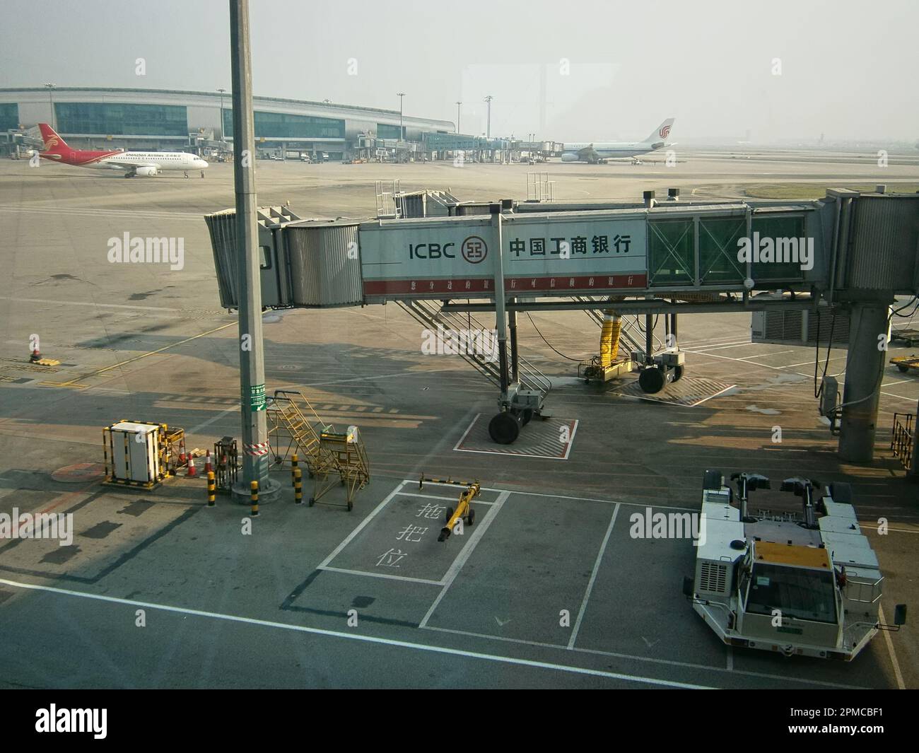 A jet bridge with aircraft in the background as viewed from the ...