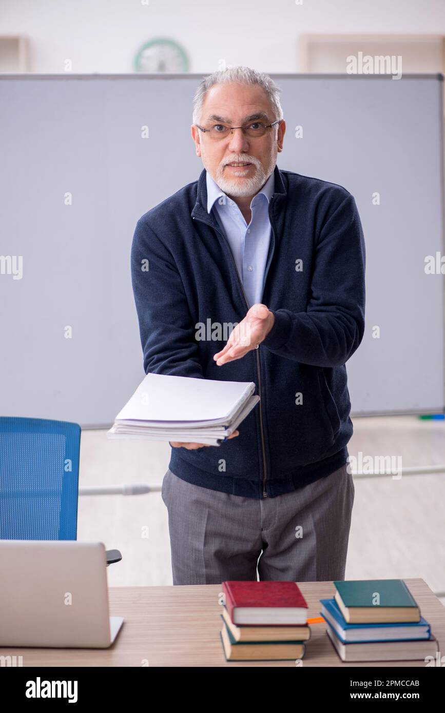 Old teacher in the classroom Stock Photo - Alamy