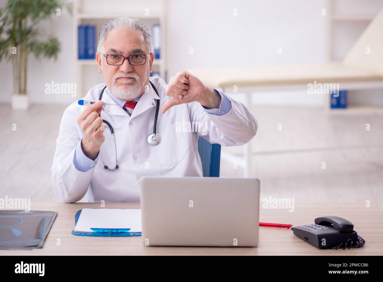 Old doctor working at the hospital Stock Photo - Alamy