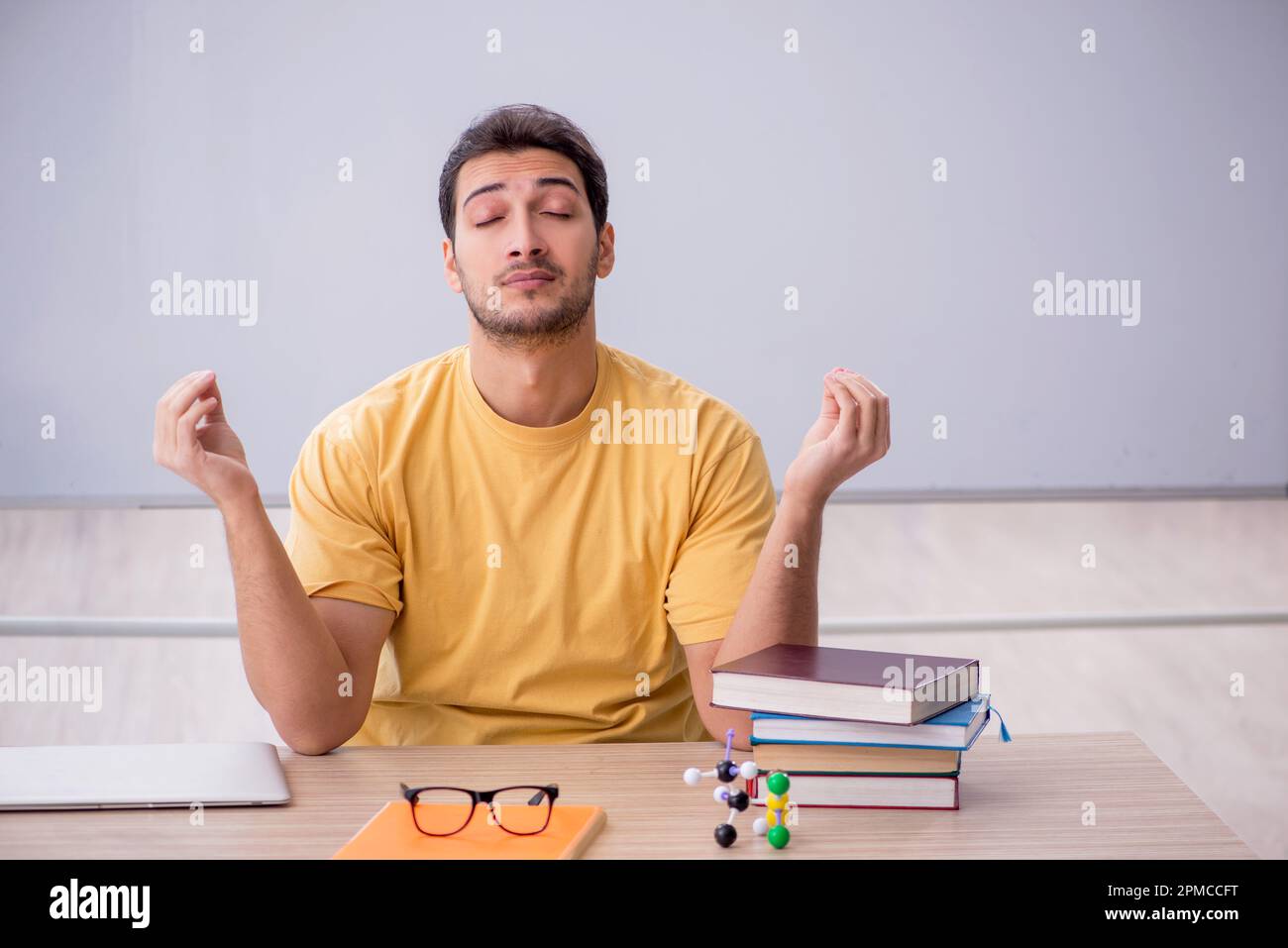 Young student sitting in the classroom Stock Photo - Alamy