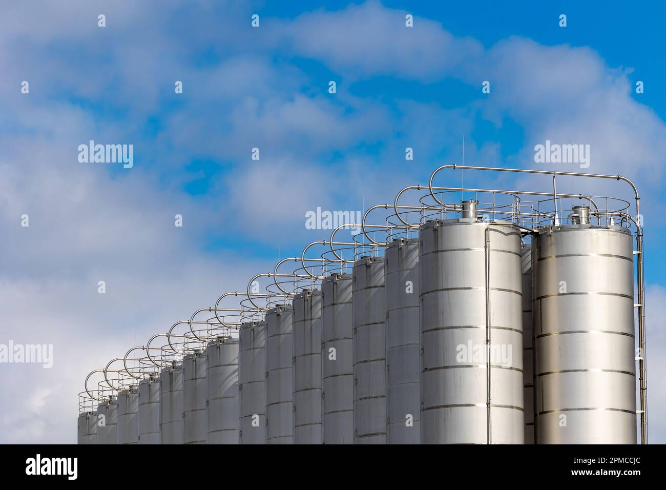Stainless steel silos against the blue sky. Warehouses for storage of ...