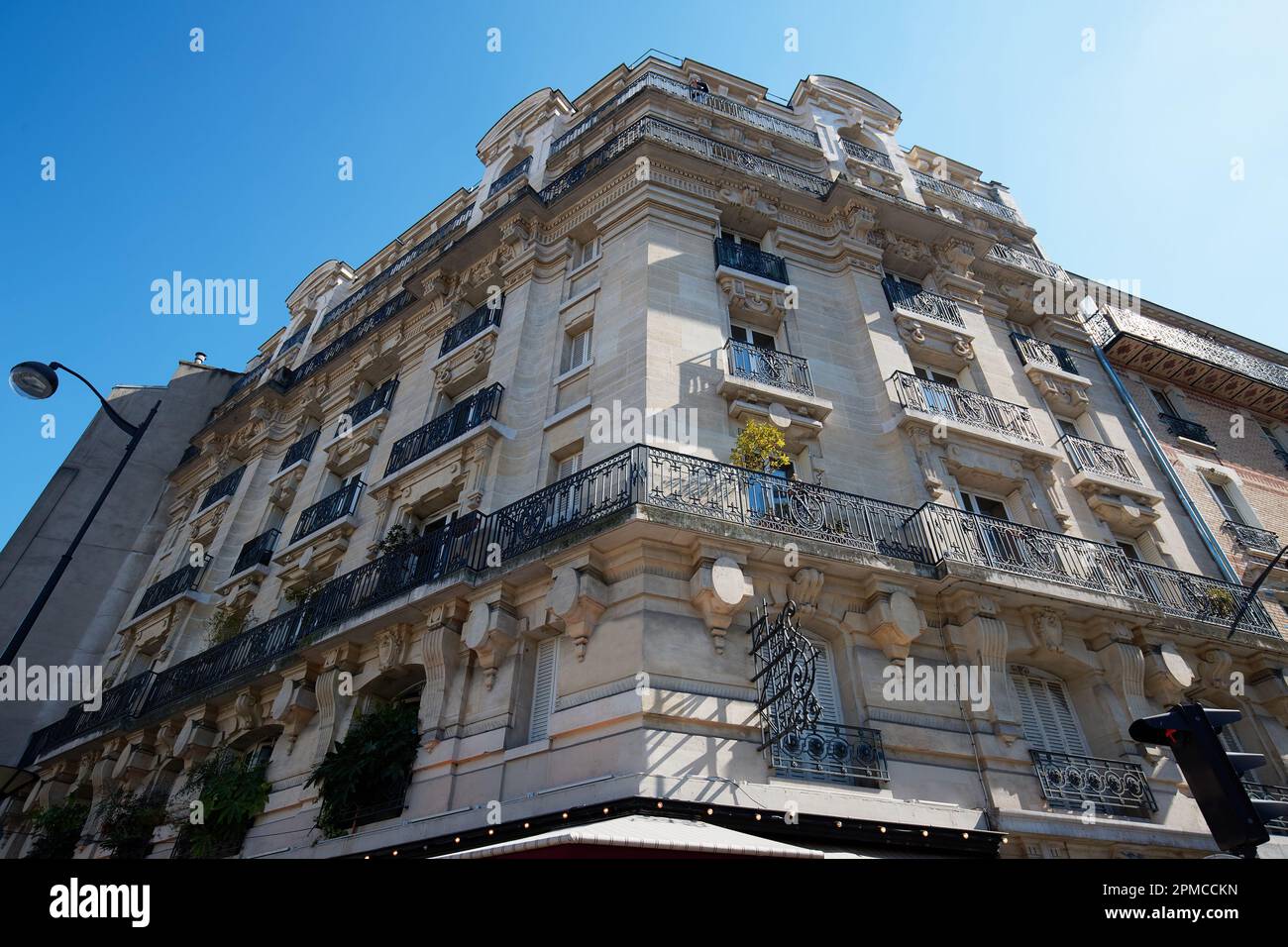 The facade of traditional French house with typical balconies and ...