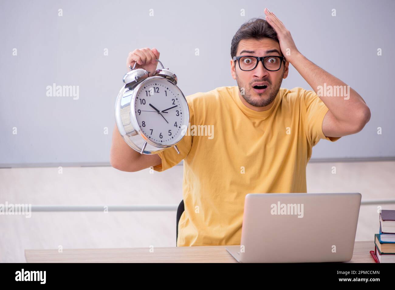 Young student in time management concept Stock Photo - Alamy