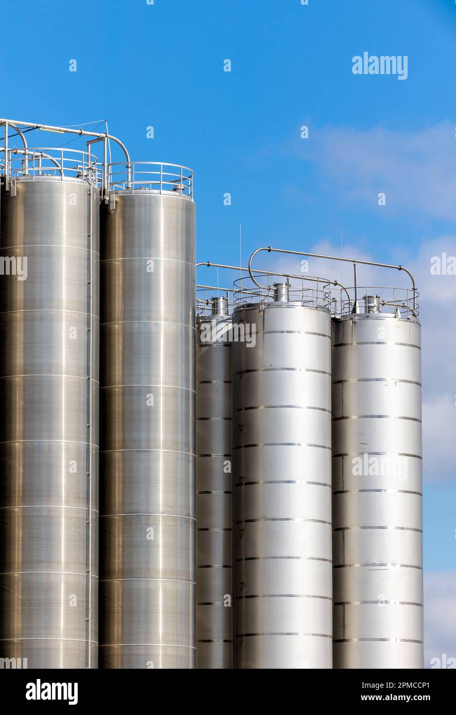 Stainless steel silos against the blue sky. Warehouses for storage of ...