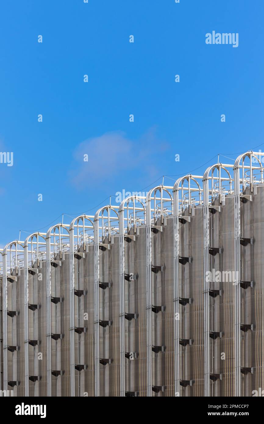 Stainless steel silos against the blue sky. Warehouses for storage of ...