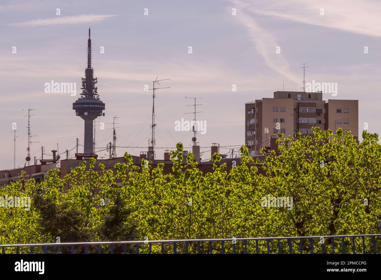 Facades, trees and roofs of buildings in a neighborhood of the city of ...