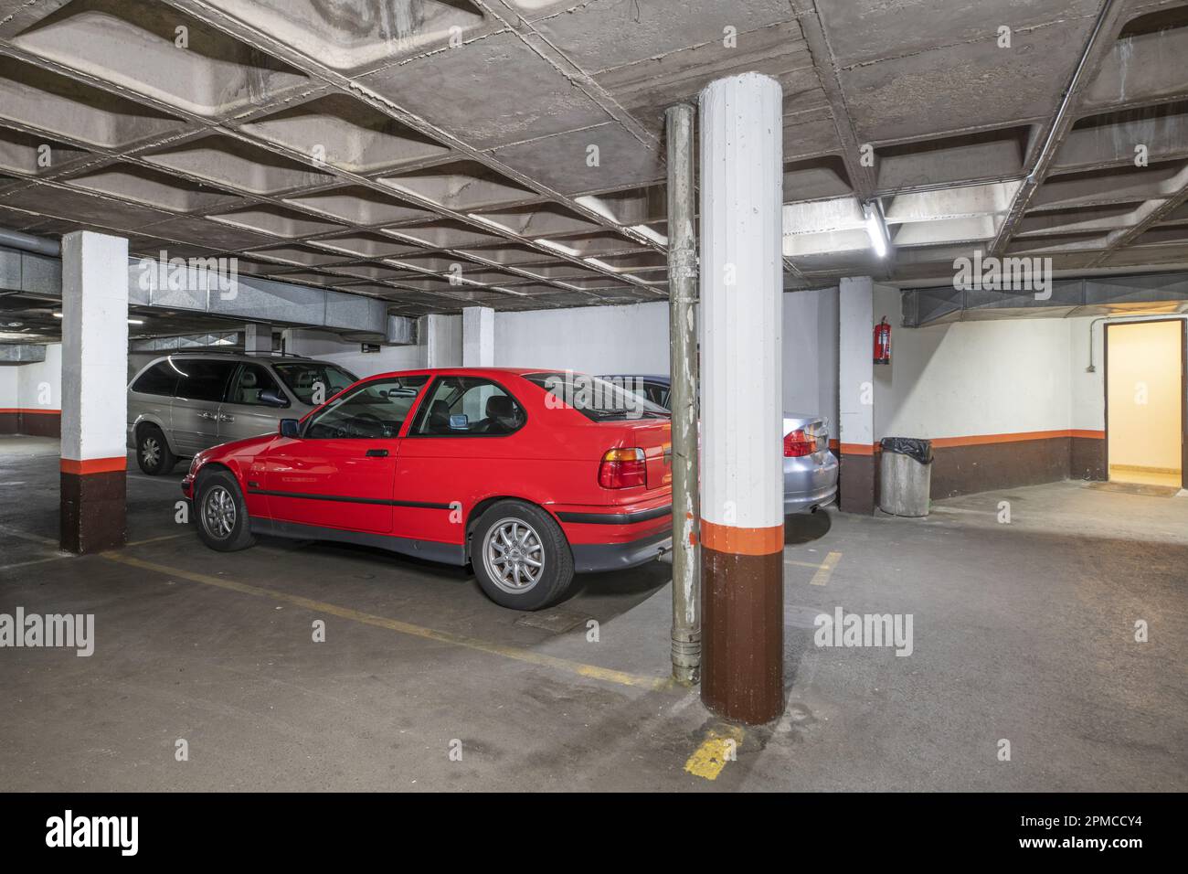 A few utility vehicles parked in the parking spaces of a residential ...