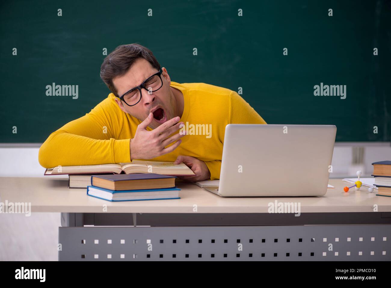 Young student sitting in the classroom Stock Photo - Alamy