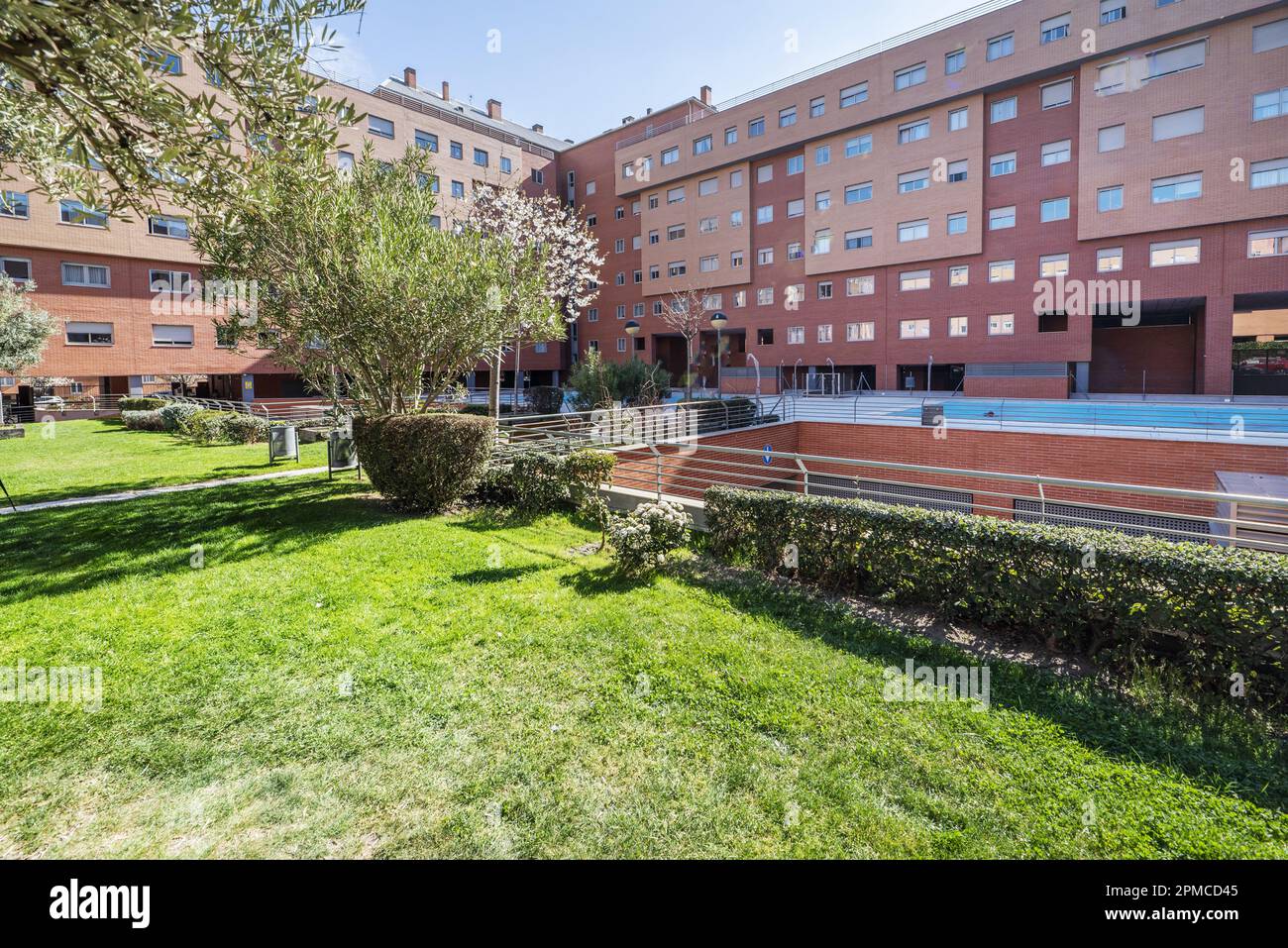 Facades of the interior patio of buildings in a common area with trees ...