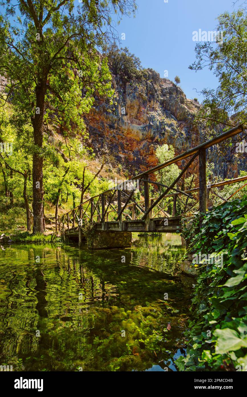 A landscape with a reflective water surface and a pedestrian walkway ...