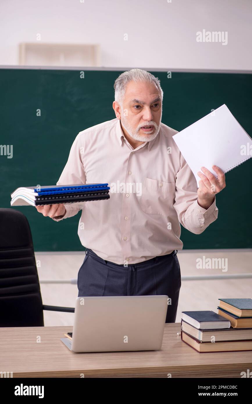 Old teacher in the classroom Stock Photo - Alamy