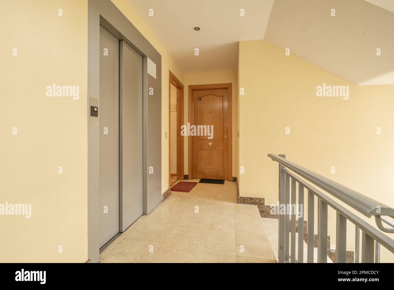 Building landing with stairs, cream marble floor and elevator access ...