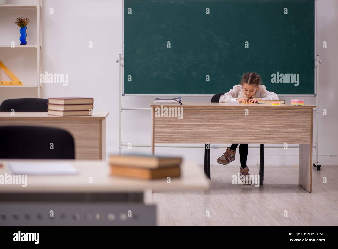 Little girl sitting in the classroom Stock Photo - Alamy