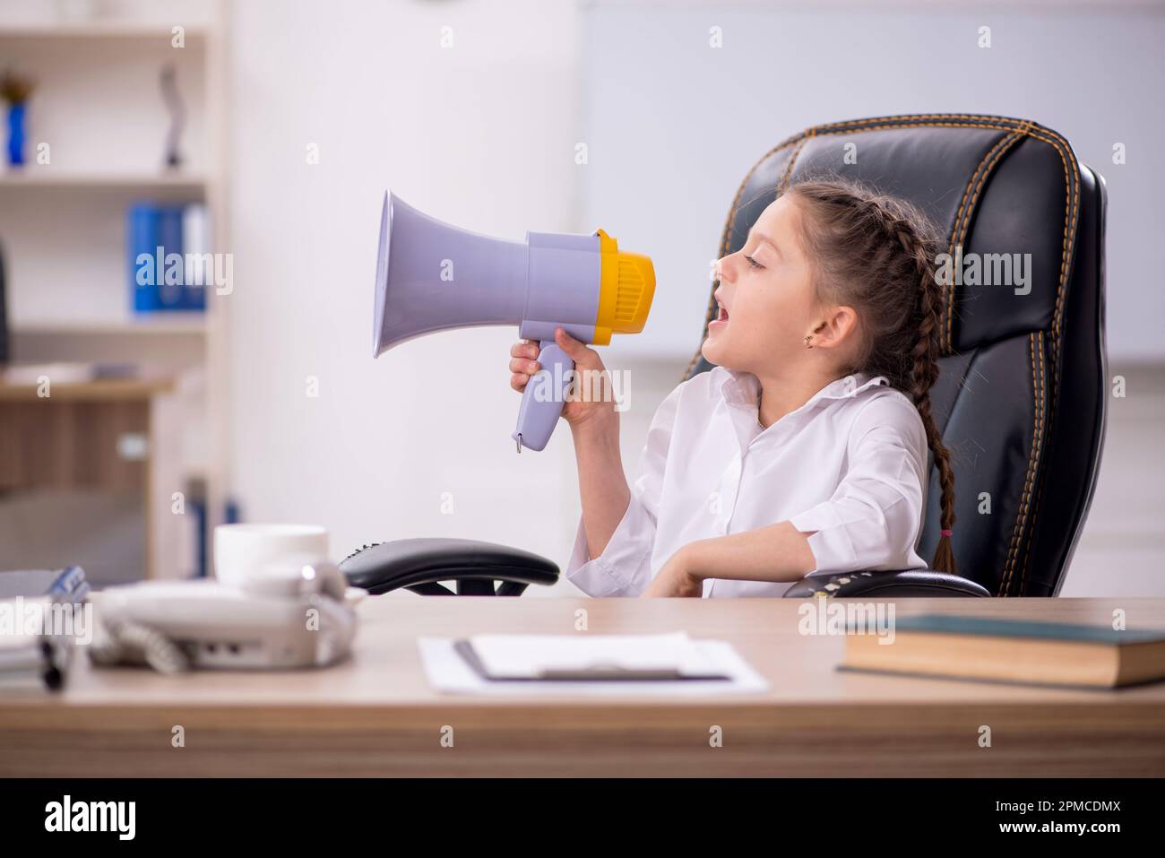 Little girl holding megaphone in the classroom Stock Photo - Alamy