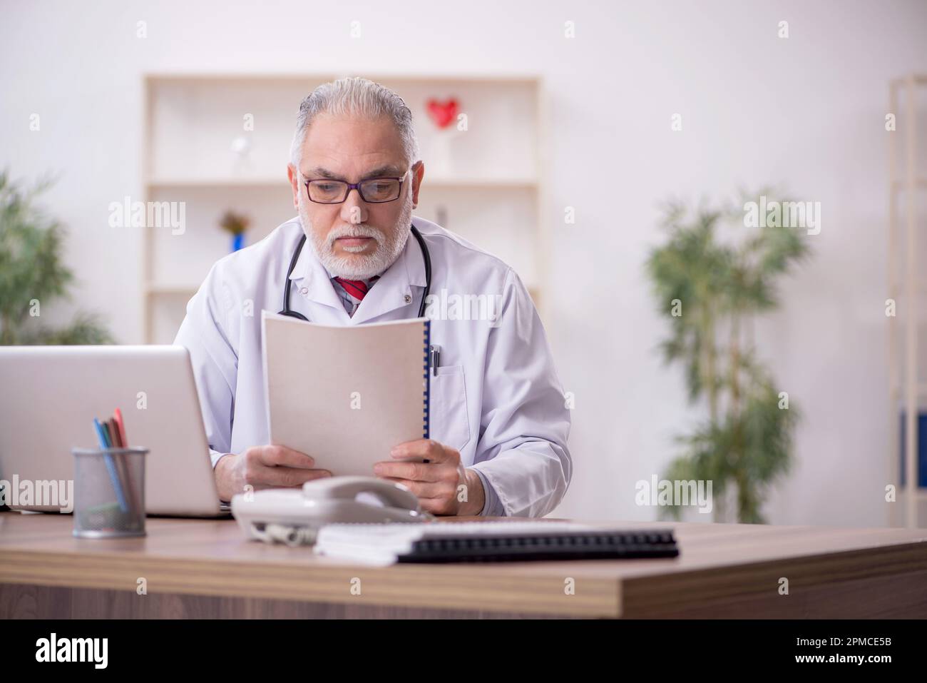 Old doctor working at the hospital Stock Photo - Alamy
