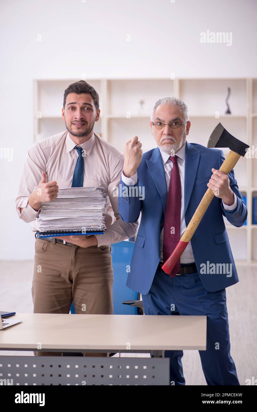 Old boss and young employee in bullying concept Stock Photo - Alamy