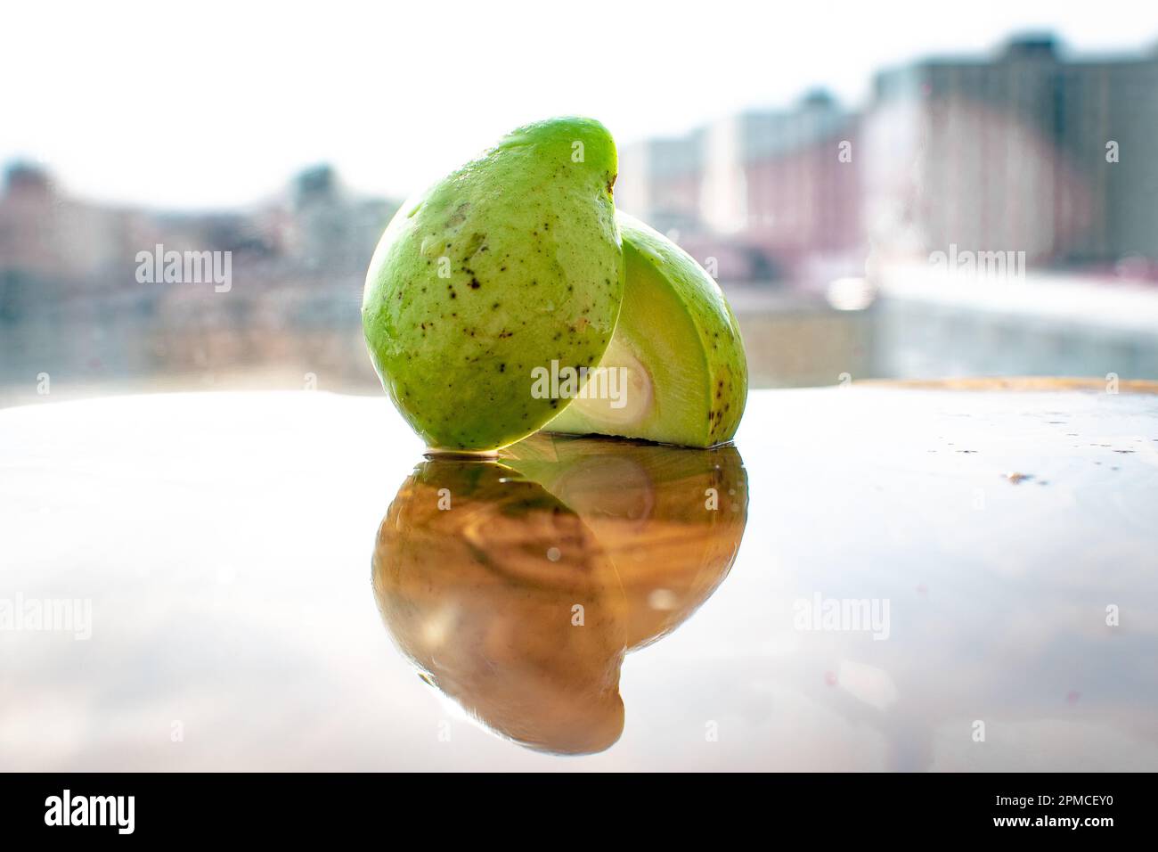Green mango or baby mango is a small round mango with a vibrant emerald ...