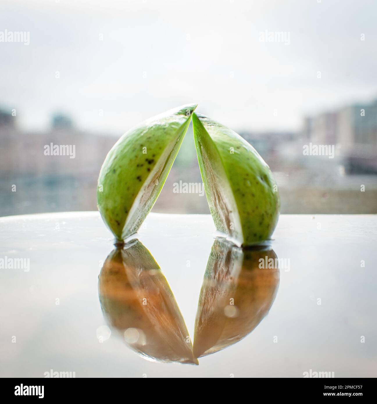 Green mango or baby mango is a small round mango with a vibrant emerald ...