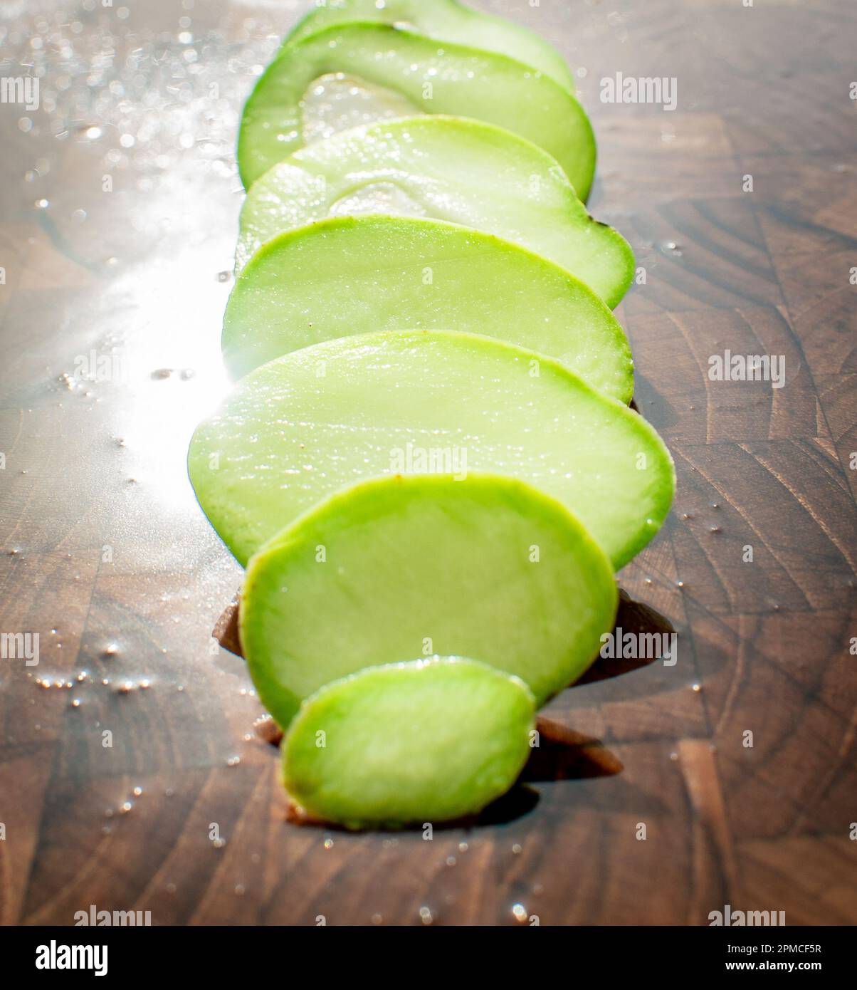 Green mango or baby mango is a small round mango with a vibrant emerald ...