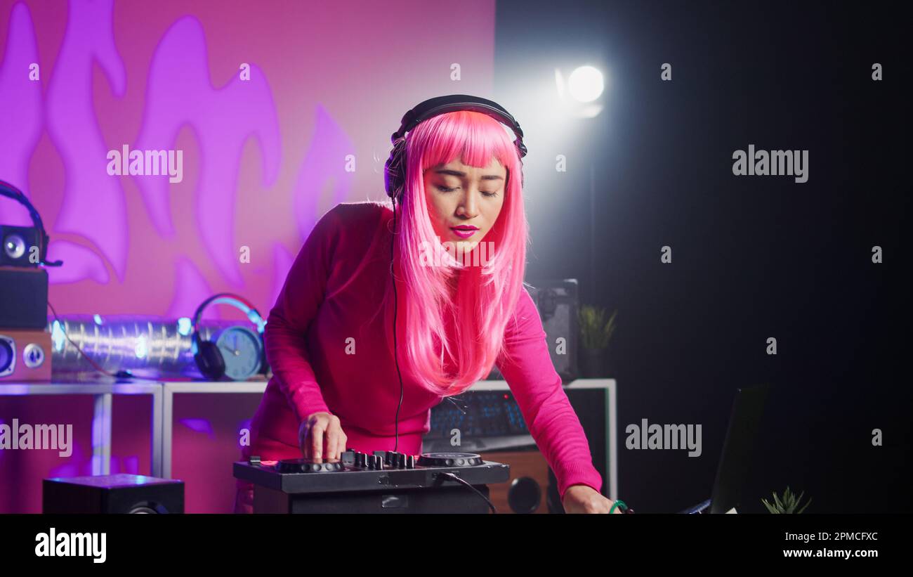 Musician standing at dj table mixing sound using professional mixer ...