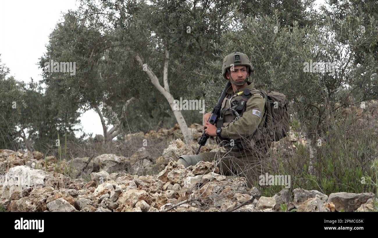 An Israeli soldier stands guard in the West Bank, Israel Stock Photo ...