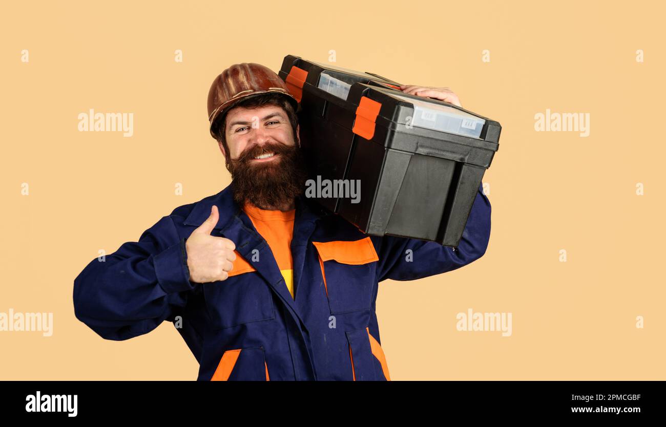 Builder with tool box show thumbs up. Repairman in overalls carry ...