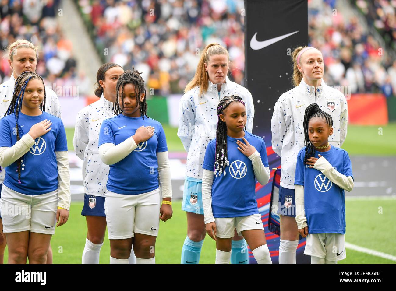 USA players line up with local girls to say the Pledge of Allegiance ...