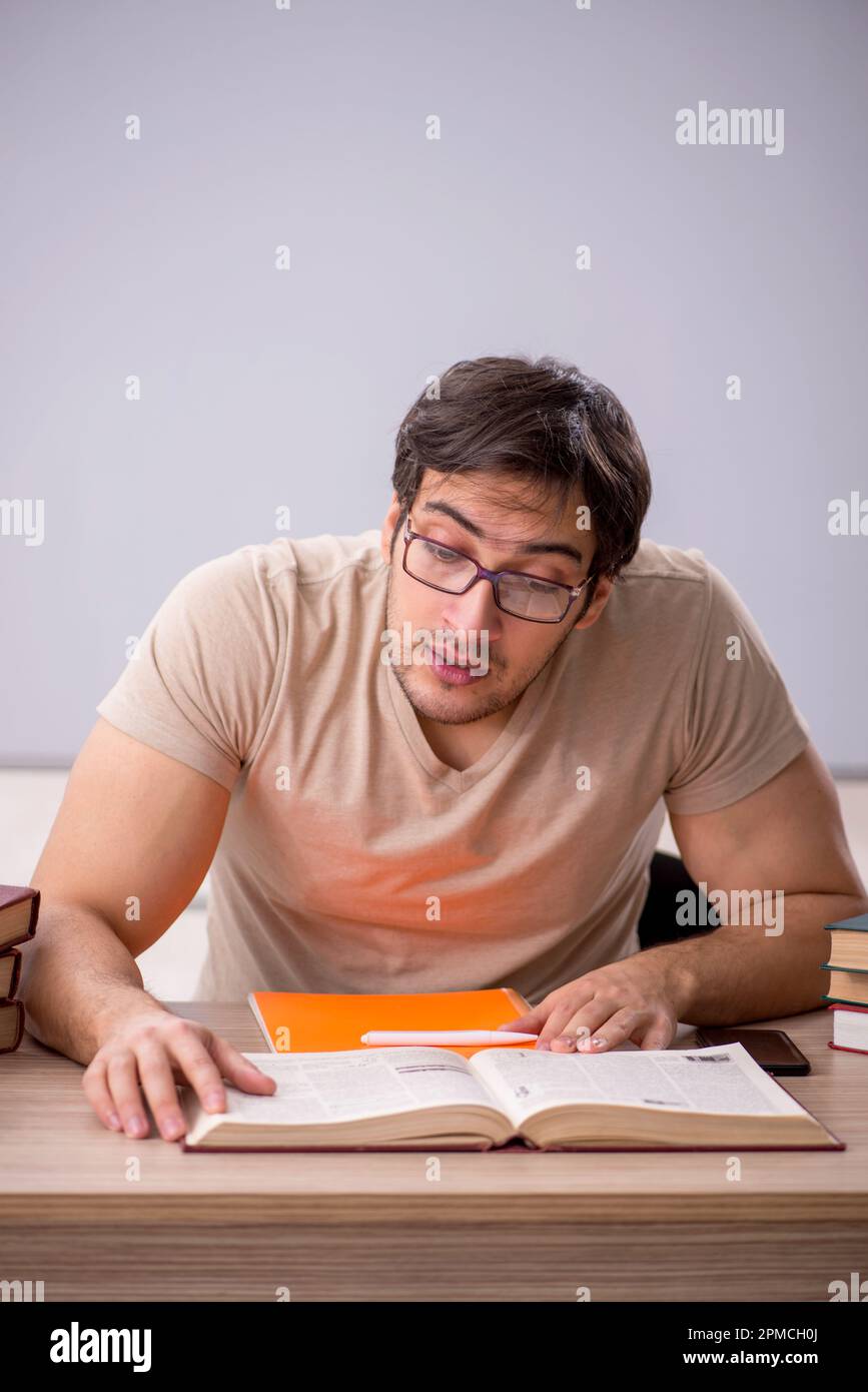 Young student sitting in the classroom Stock Photo - Alamy