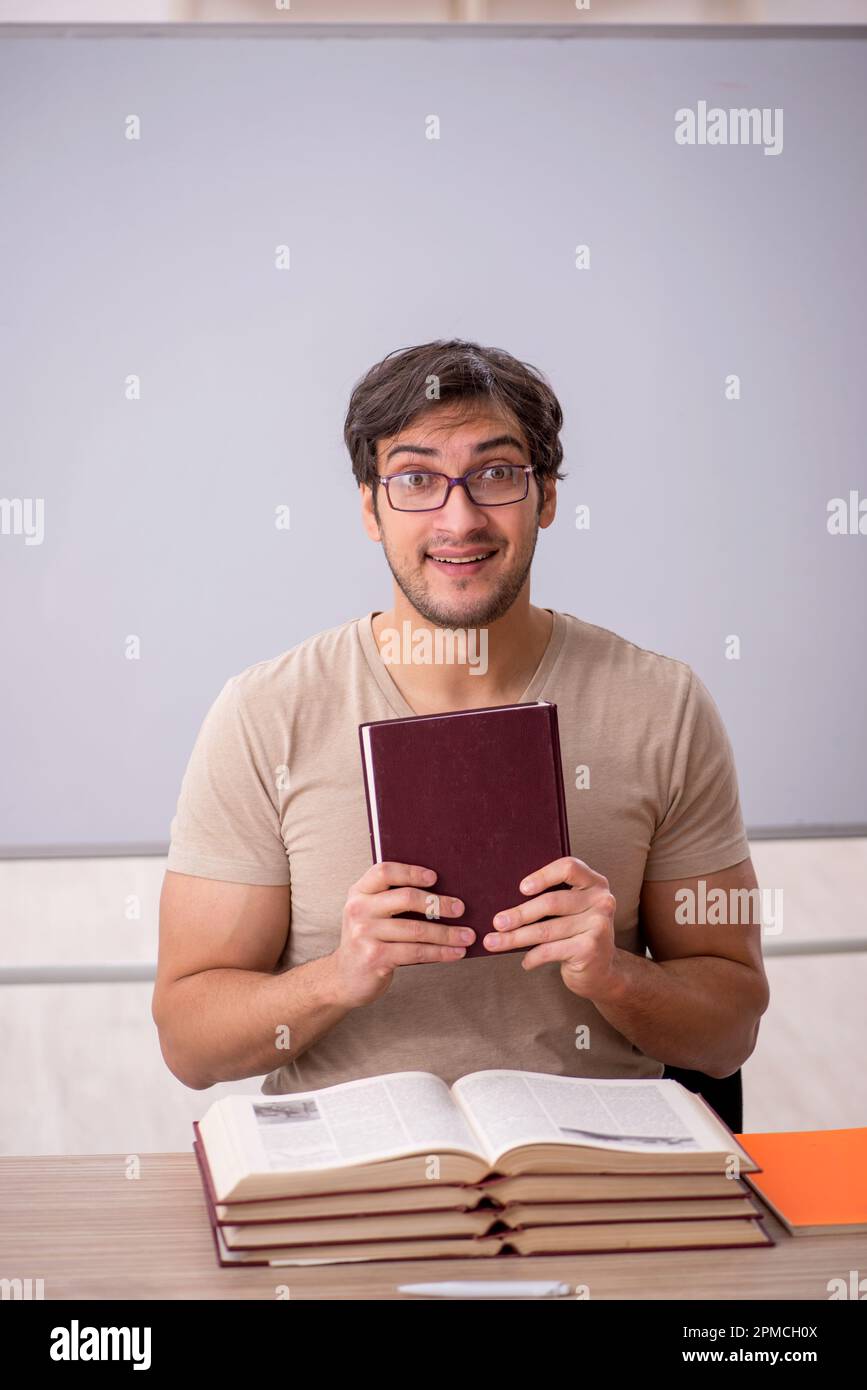 Young student sitting in the classroom Stock Photo - Alamy