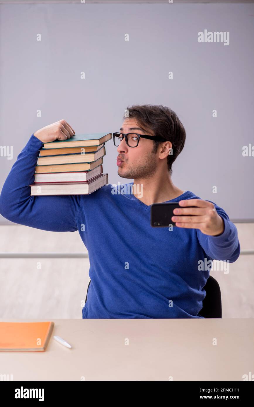 Young student preparing for exams in the classroom Stock Photo - Alamy