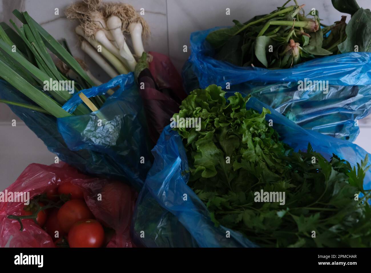 Vegetable shopping, plastic bags with different fresh vegetables on ...