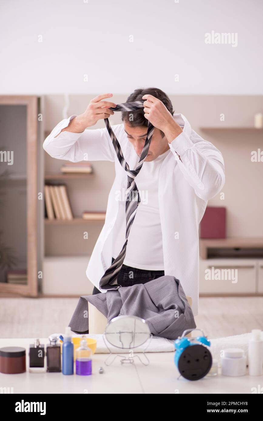 Young employee getting up late at home Stock Photo - Alamy