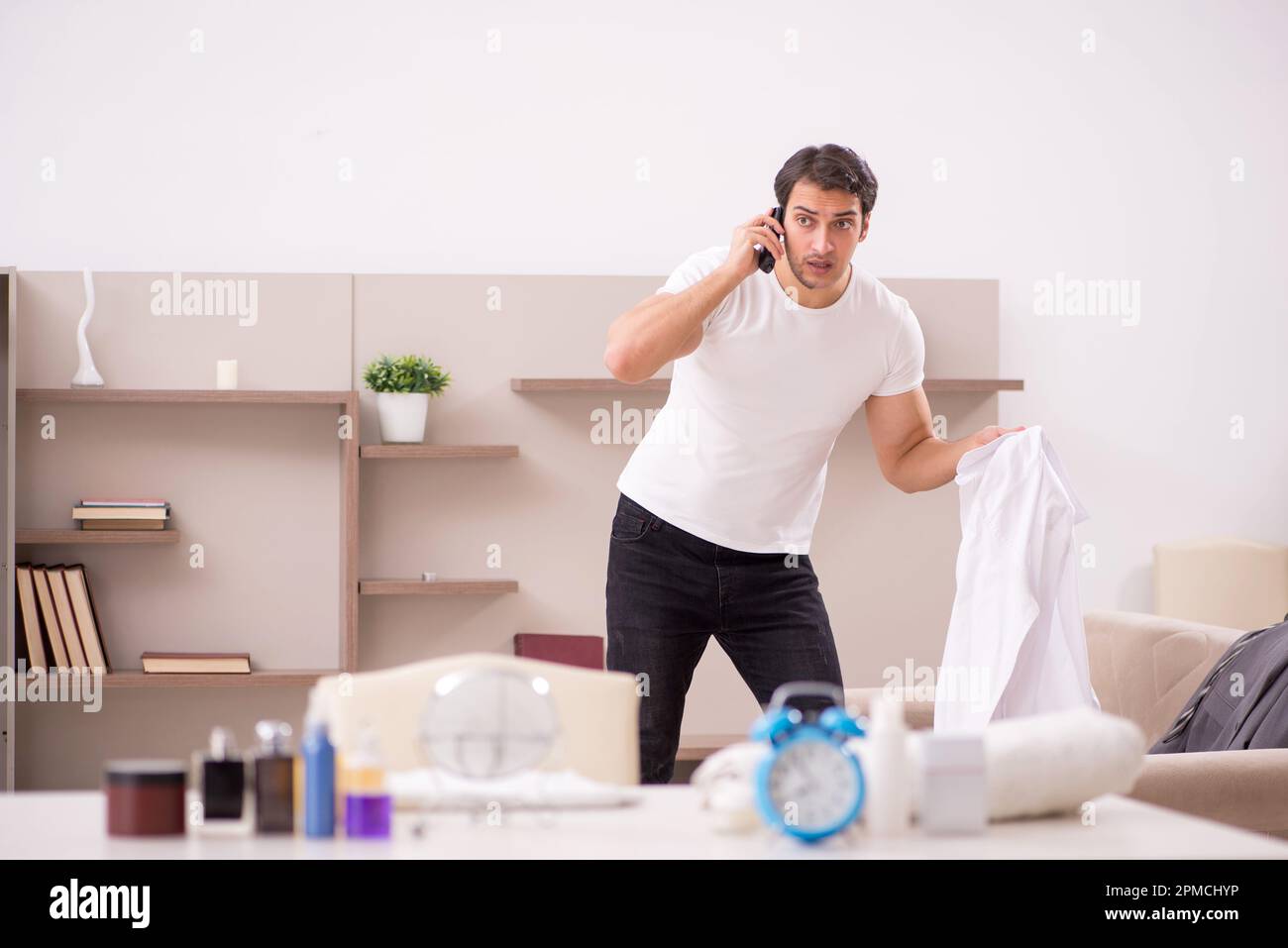 Young employee getting up late at home Stock Photo - Alamy