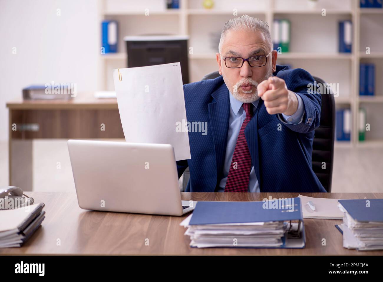 Old employee working in the office Stock Photo - Alamy