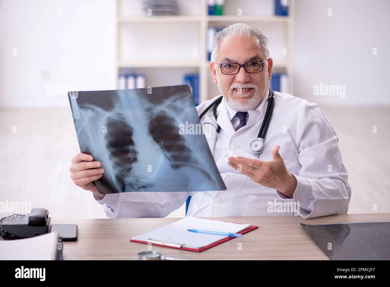 Old doctor radiologist working in the clinic Stock Photo - Alamy