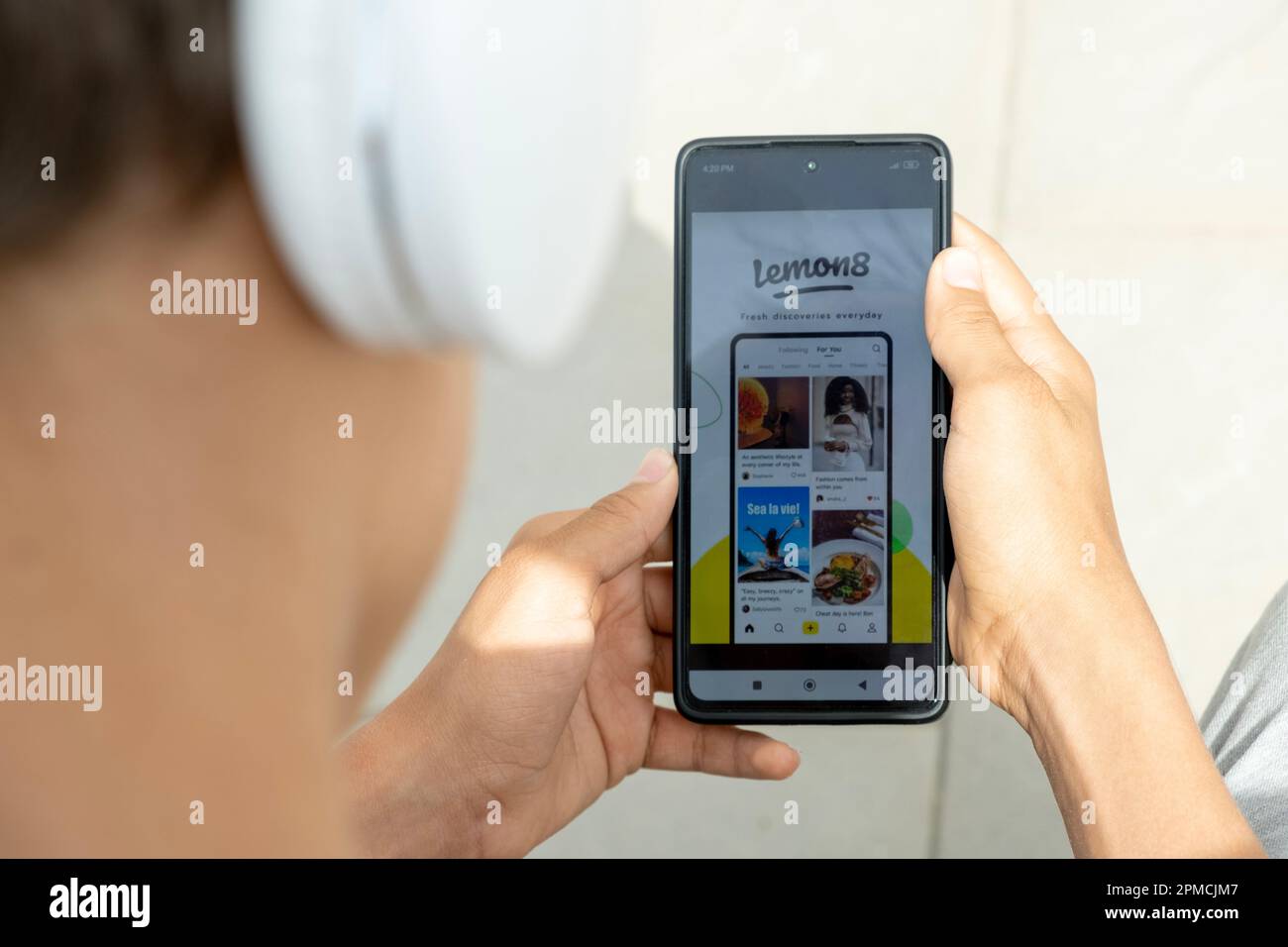 Benidorm, Spain - April 06, 2023: Teenage boy show phone with open content sharing platform with ...