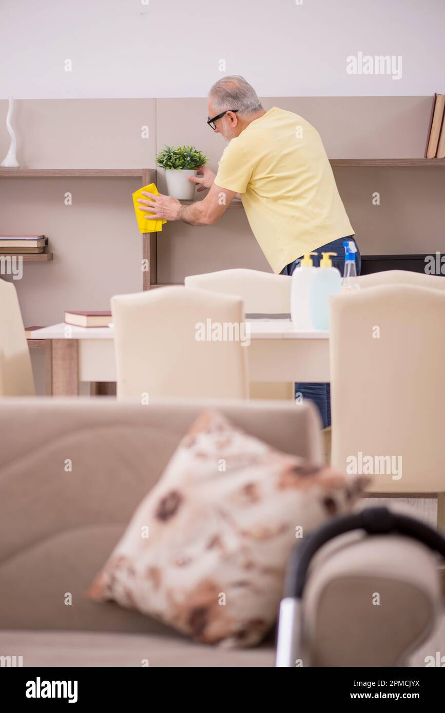 Old man cleaning the house Stock Photo - Alamy