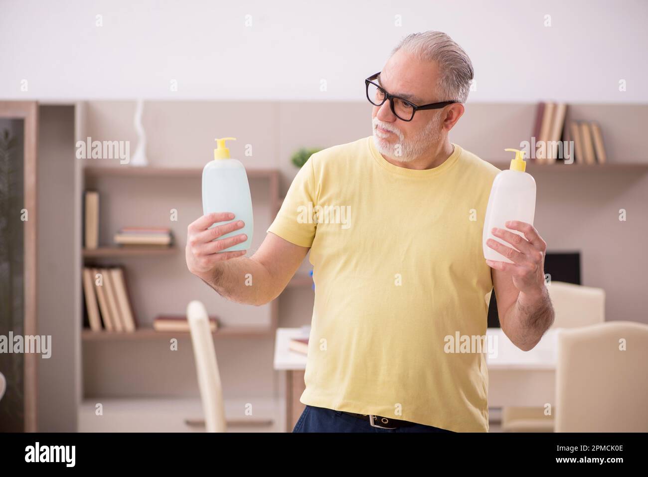 Old man cleaning the house Stock Photo - Alamy