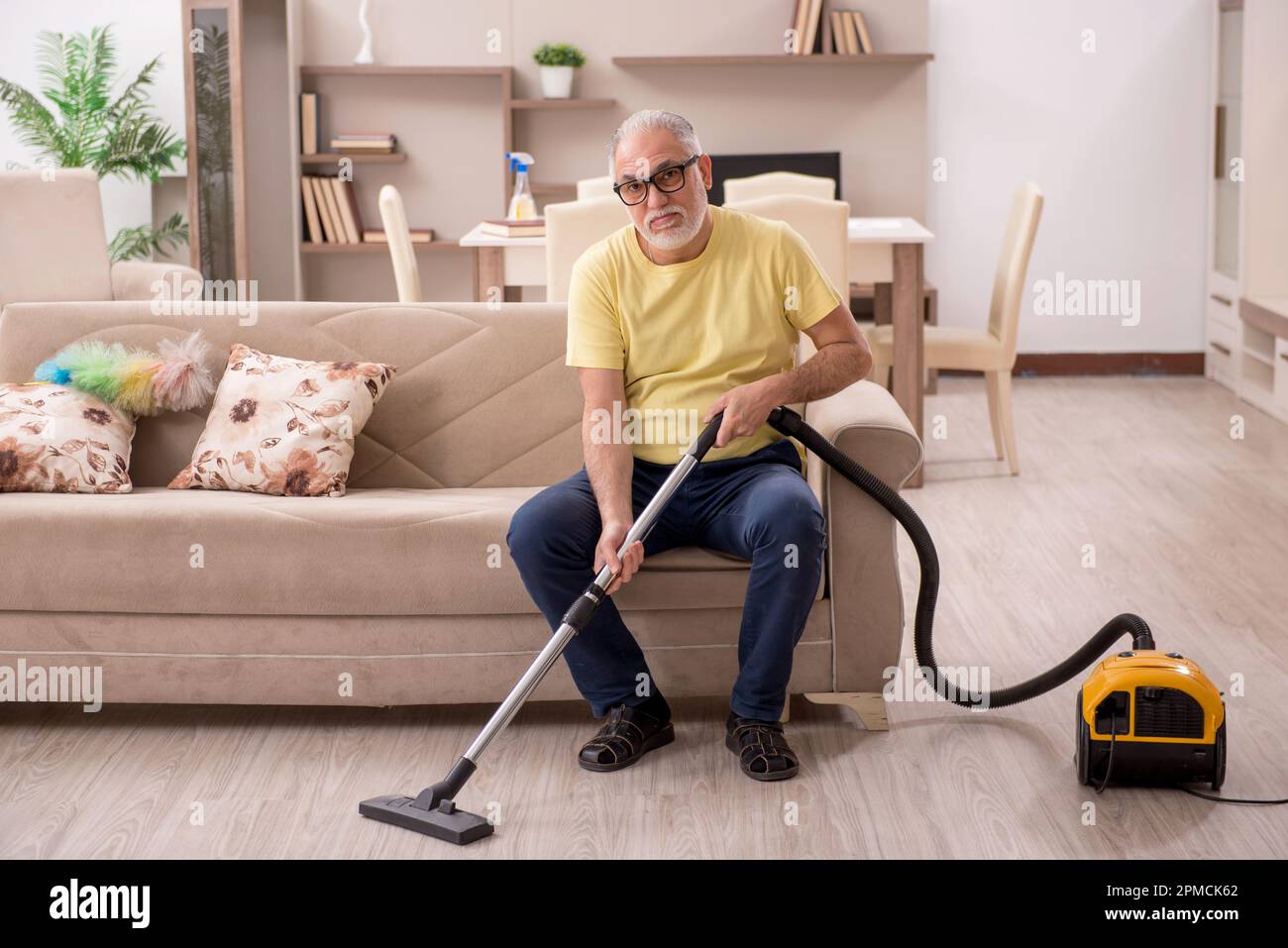Old man cleaning the house Stock Photo - Alamy