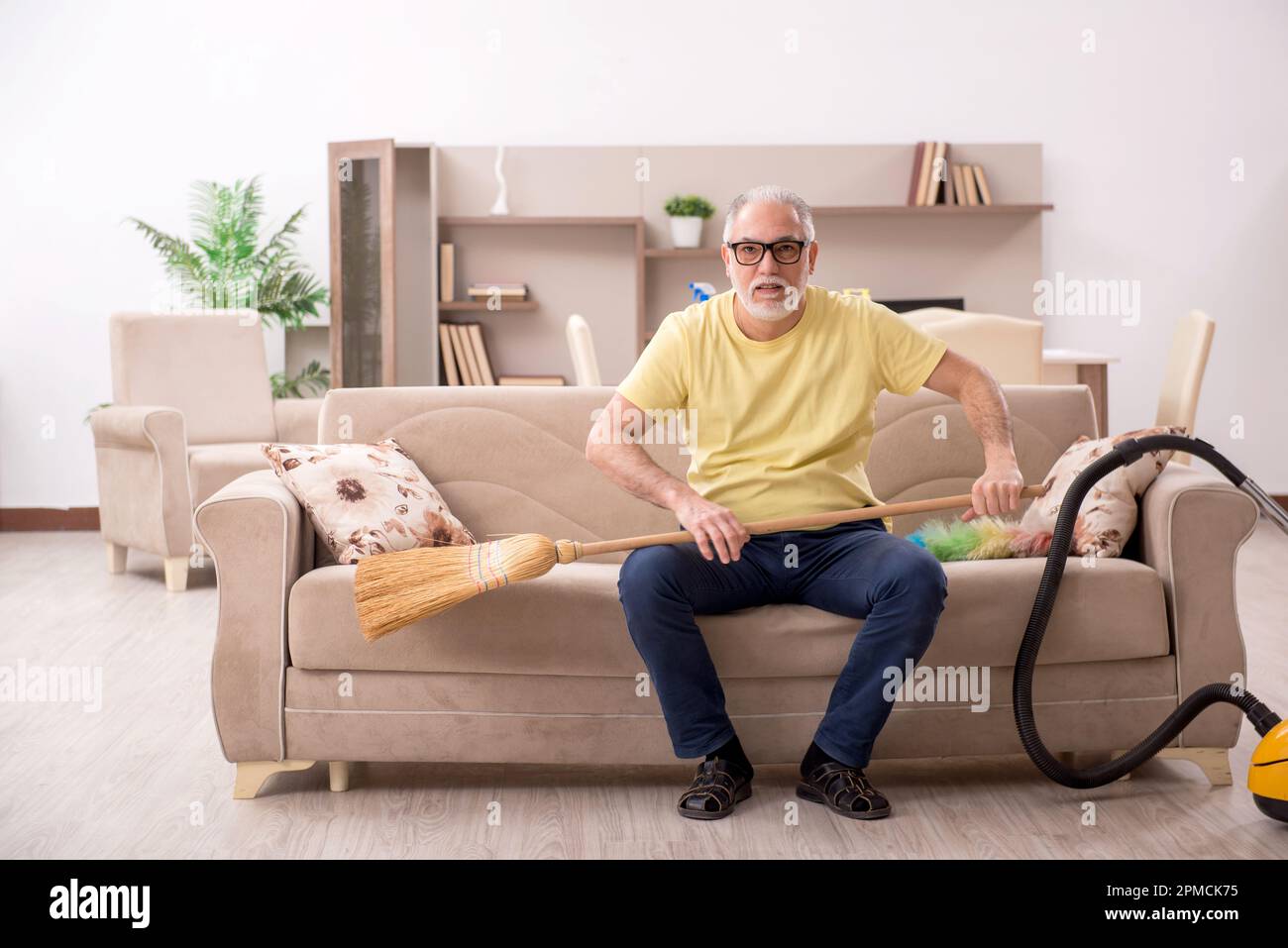 Old man cleaning the house Stock Photo - Alamy