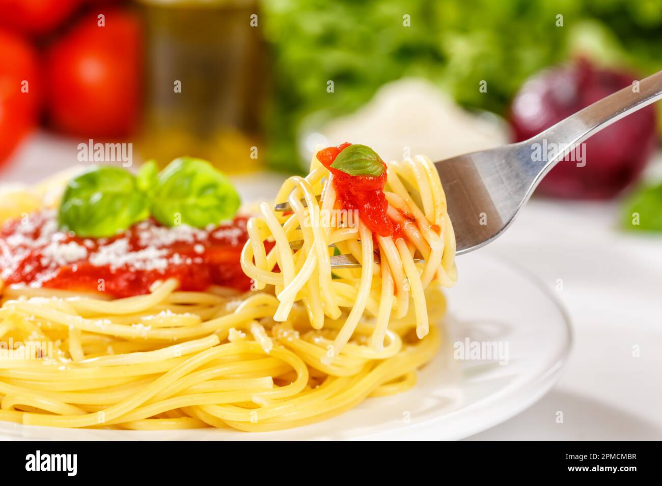 Spaghetti meal from Italy eat eating on a fork pasta lunch with tomato ...