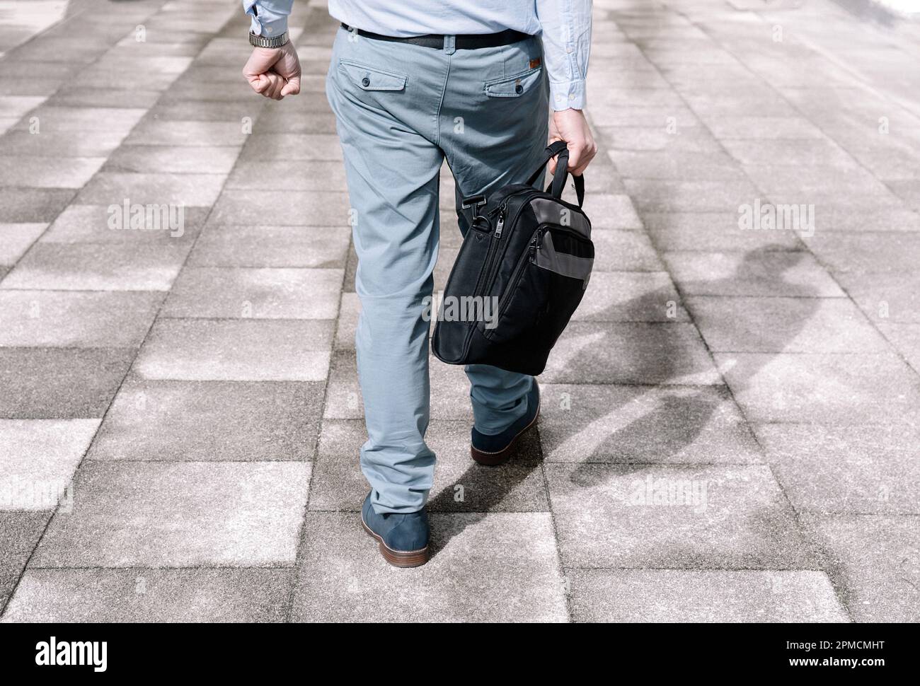 Businessman in a light-colored suit and dark briefcase going to work ...