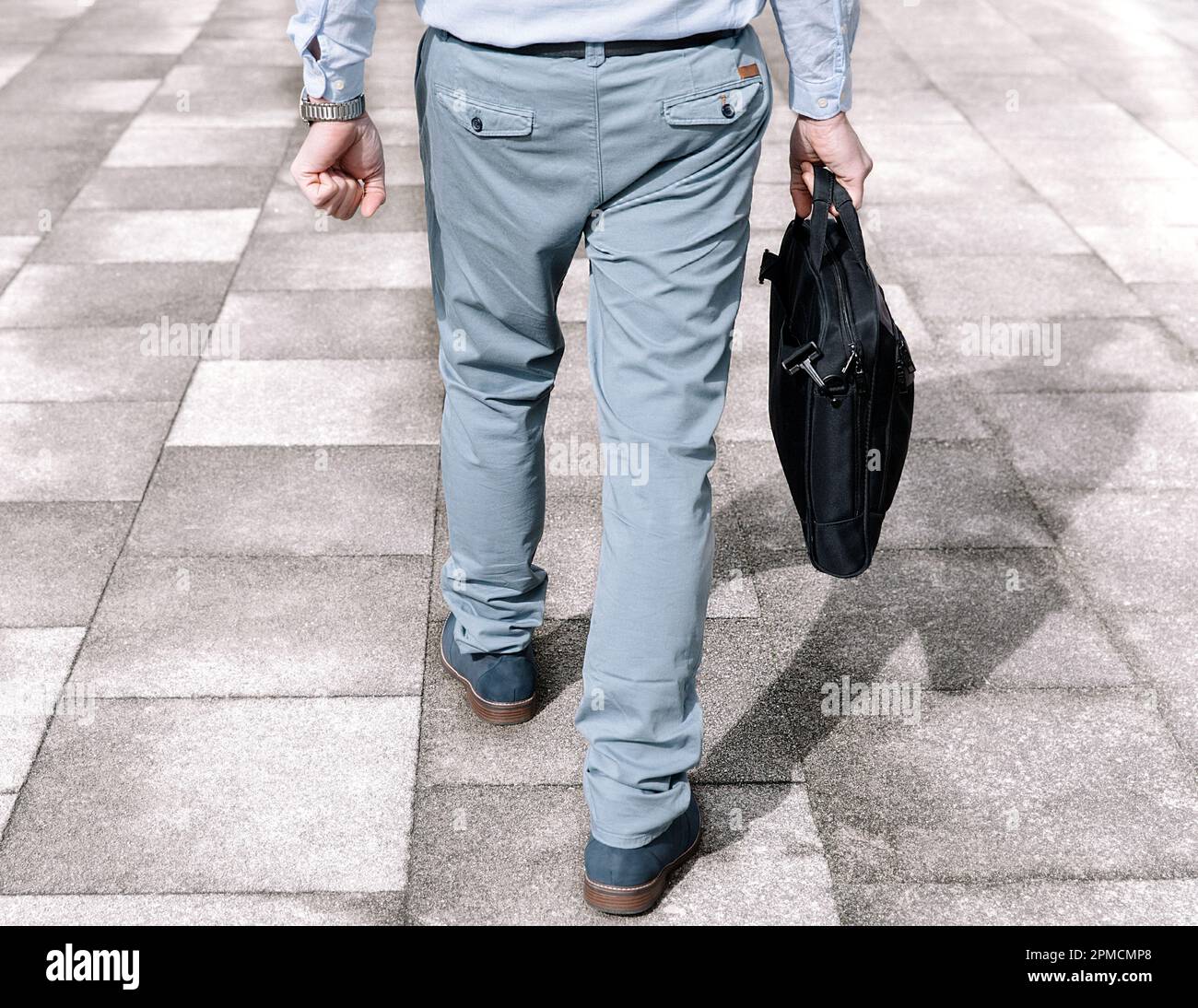 Businessman in a light-colored suit and dark briefcase going to work ...