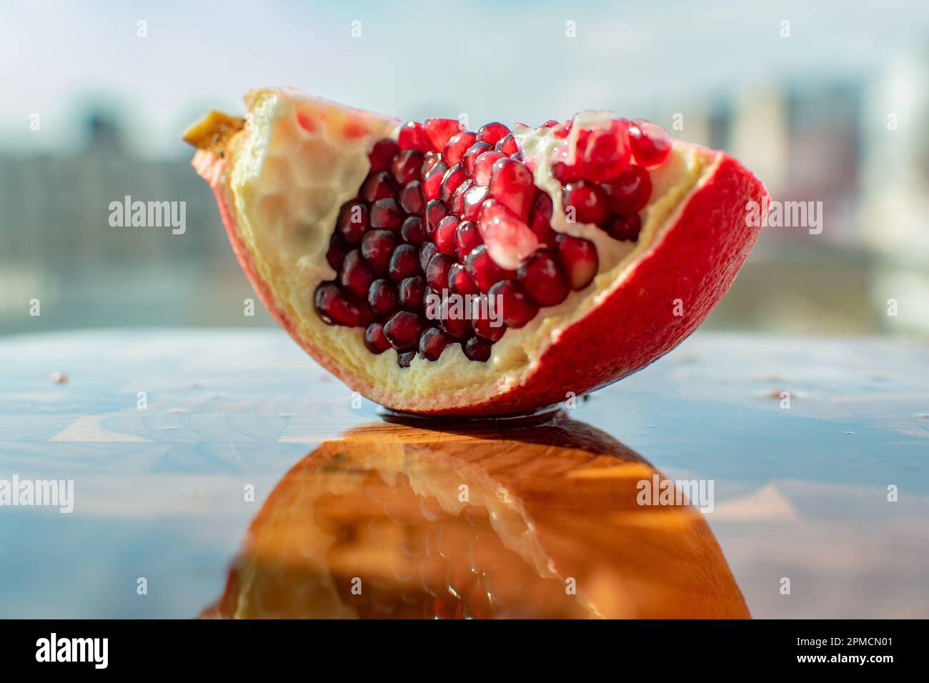 Close-up of pomegranate with its vibrant red color. The small pods are ...