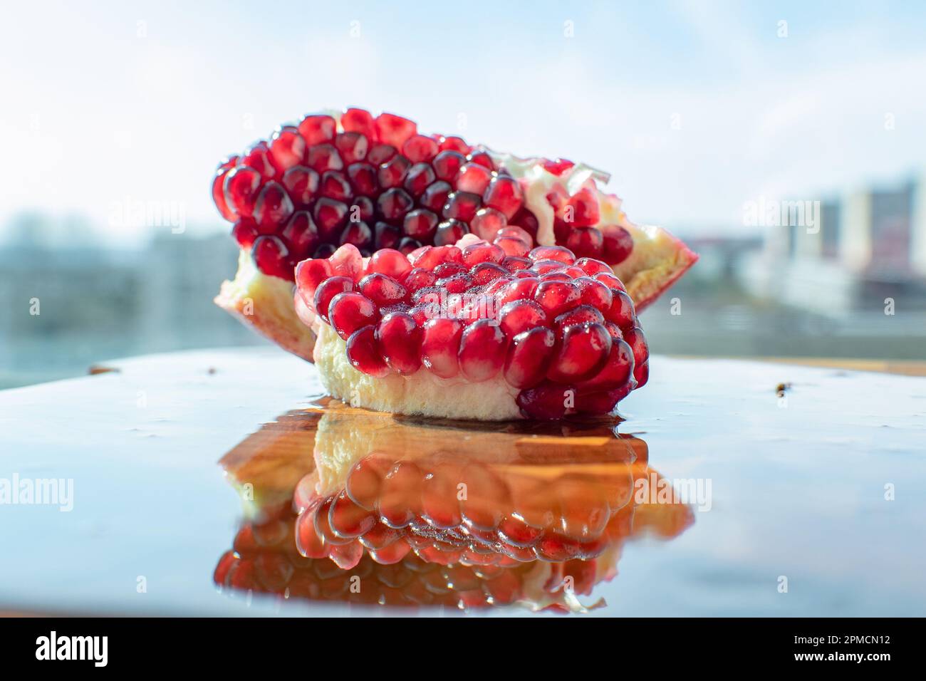 Close-up of pomegranate with its vibrant red color. The small pods are ...
