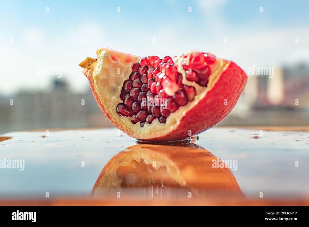 Close-up of pomegranate with its vibrant red color. The small pods are ...