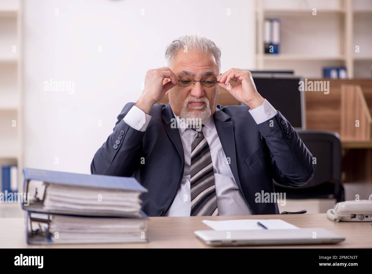 Old boss employee working at workplace Stock Photo - Alamy